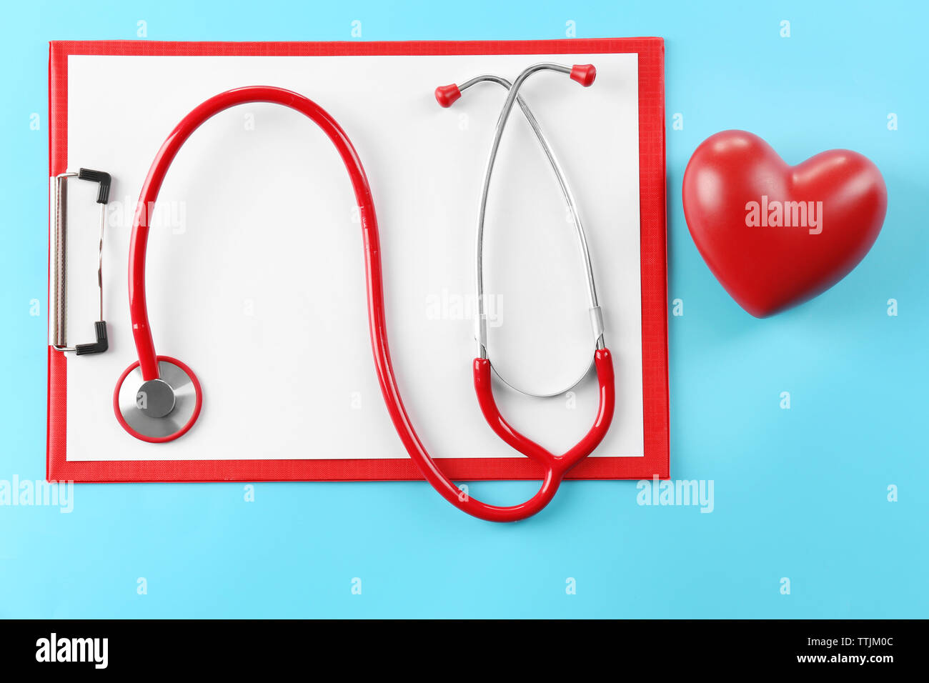 Red stethoscope with prescription on blue background Stock Photo - Alamy