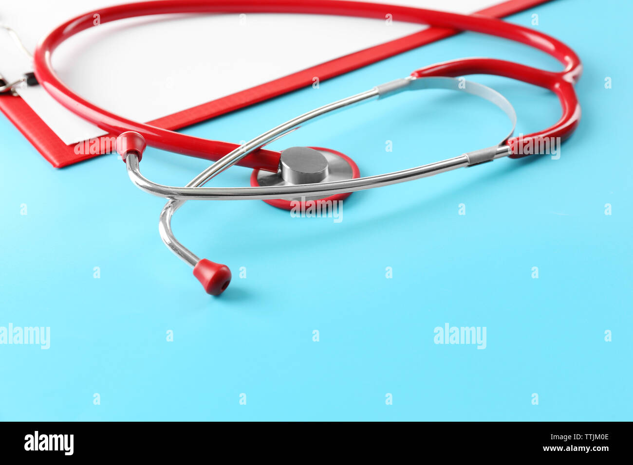 Red stethoscope with prescription on blue background Stock Photo - Alamy
