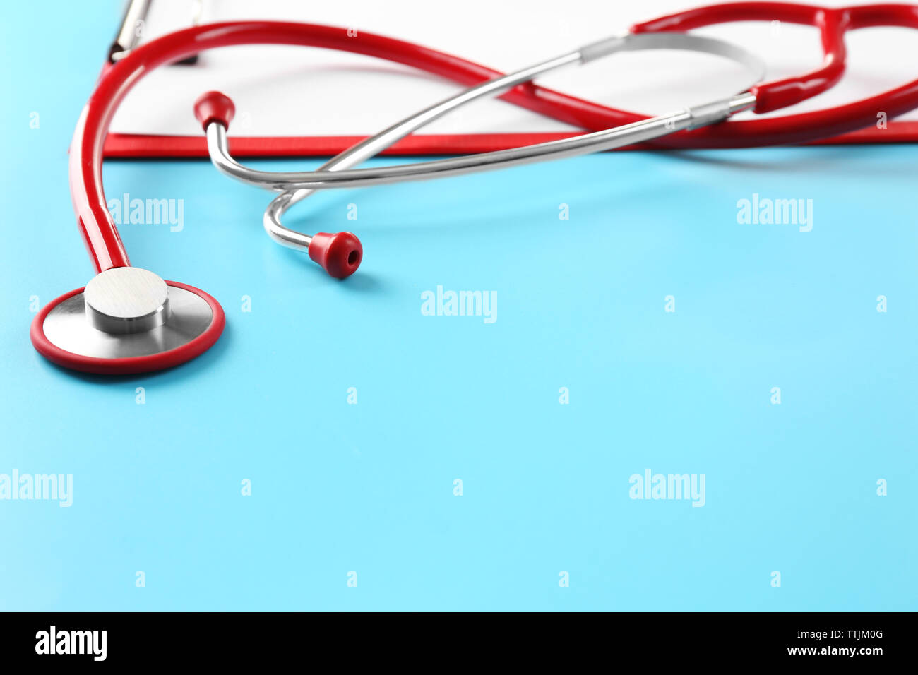 Red stethoscope with prescription on blue background Stock Photo - Alamy