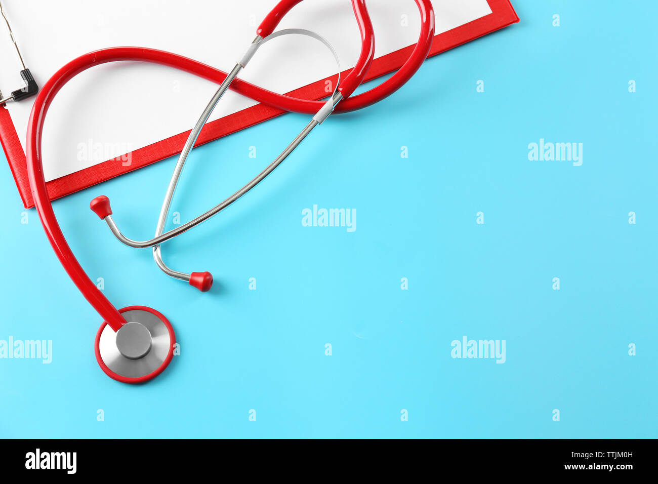 Red stethoscope with prescription on blue background Stock Photo - Alamy
