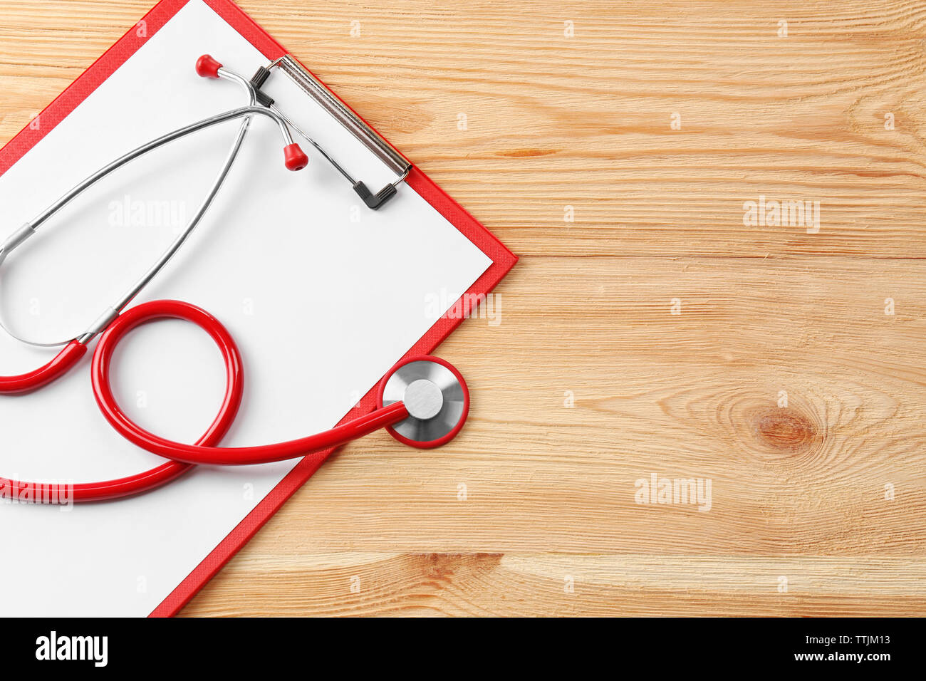 Red stethoscope with prescription on wooden background Stock Photo - Alamy