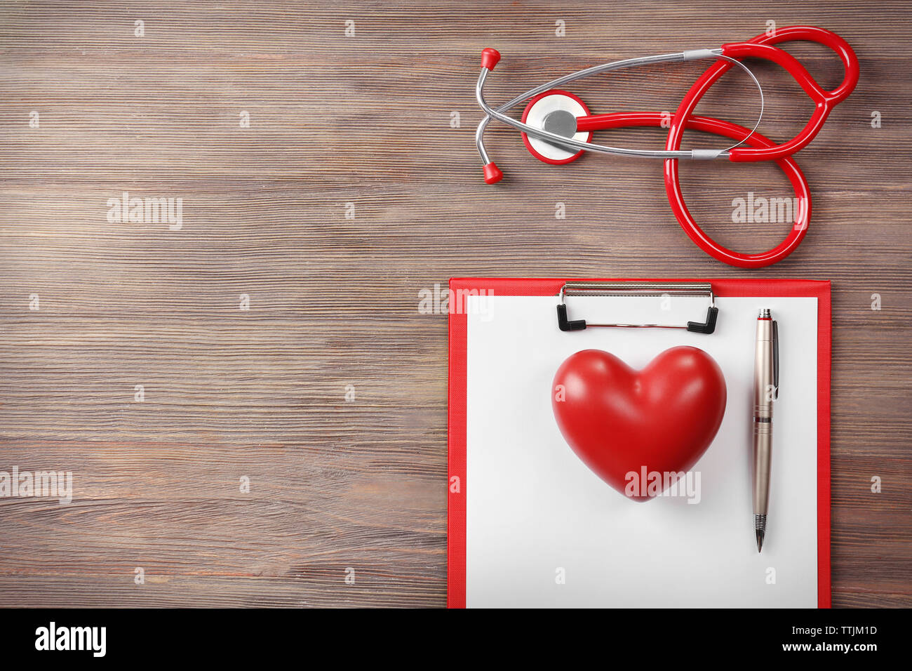 Red stethoscope with prescription on wooden background Stock Photo - Alamy