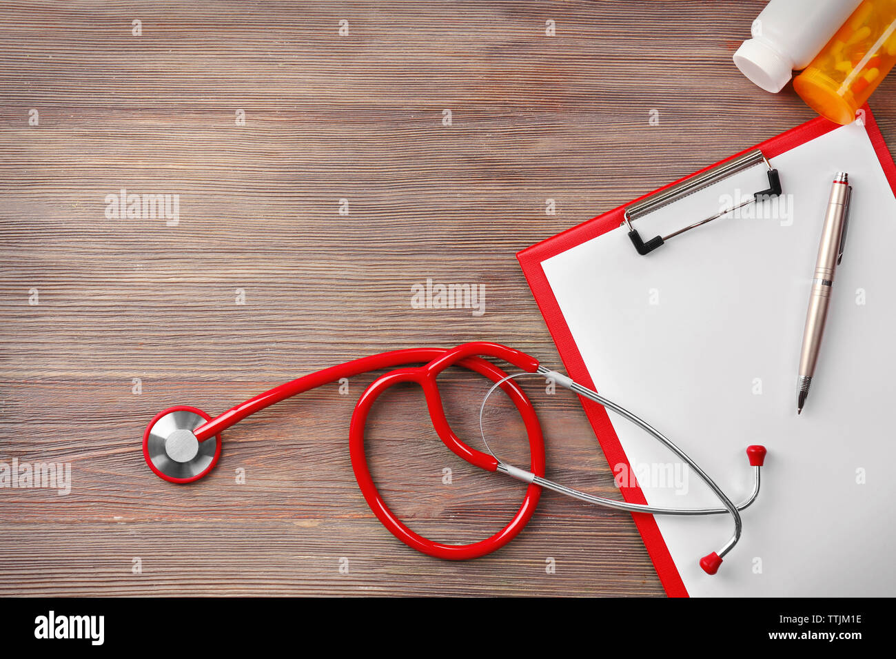 Red stethoscope with prescription on wooden background Stock Photo - Alamy