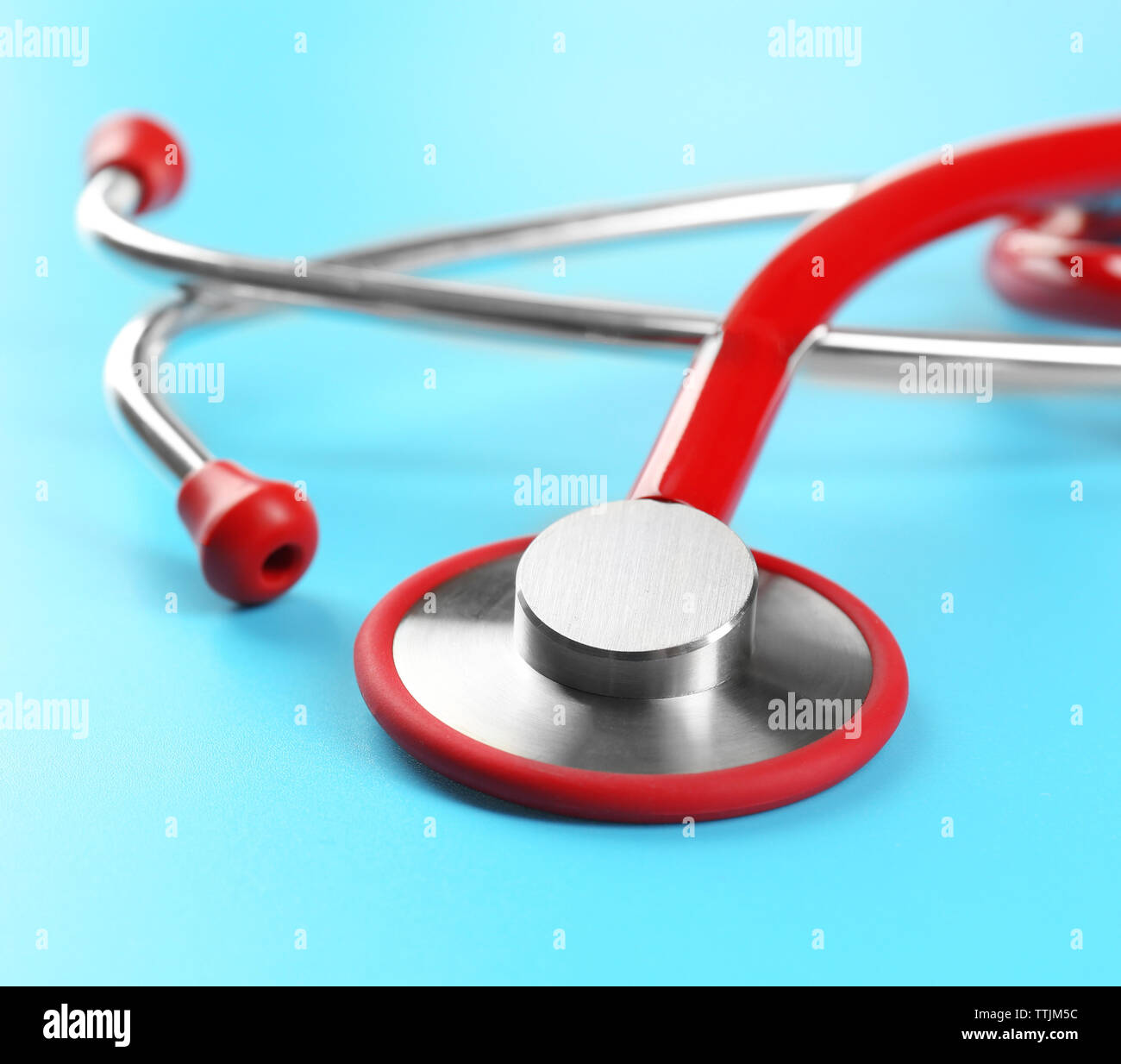 Red stethoscope on blue background Stock Photo - Alamy