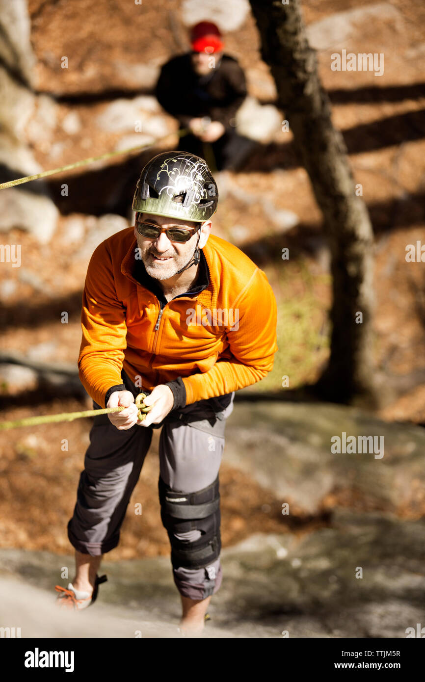 Mature man climbing up rocks hi-res stock photography and images - Alamy
