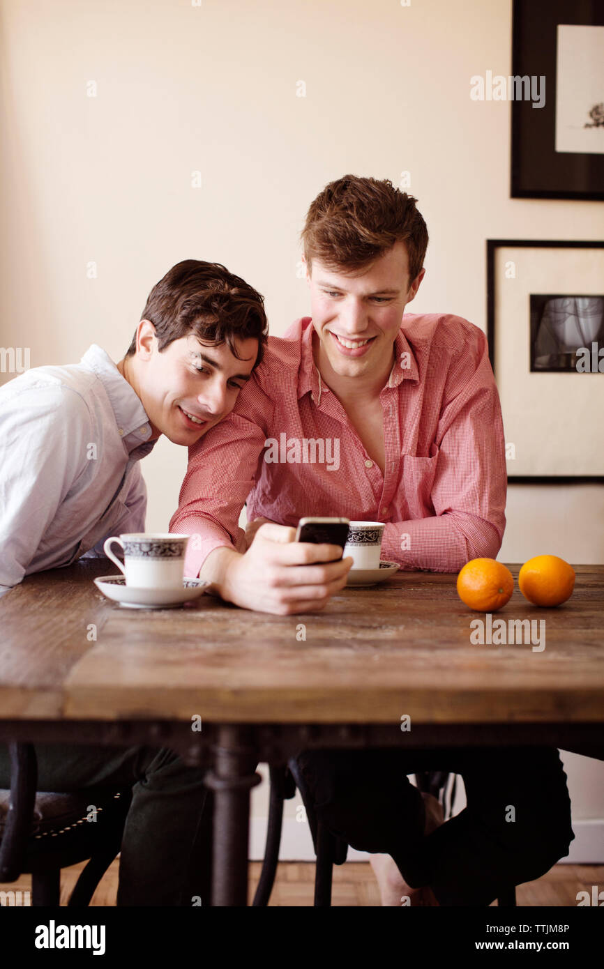 Two gay men sitting table hi-res stock photography and images - Alamy