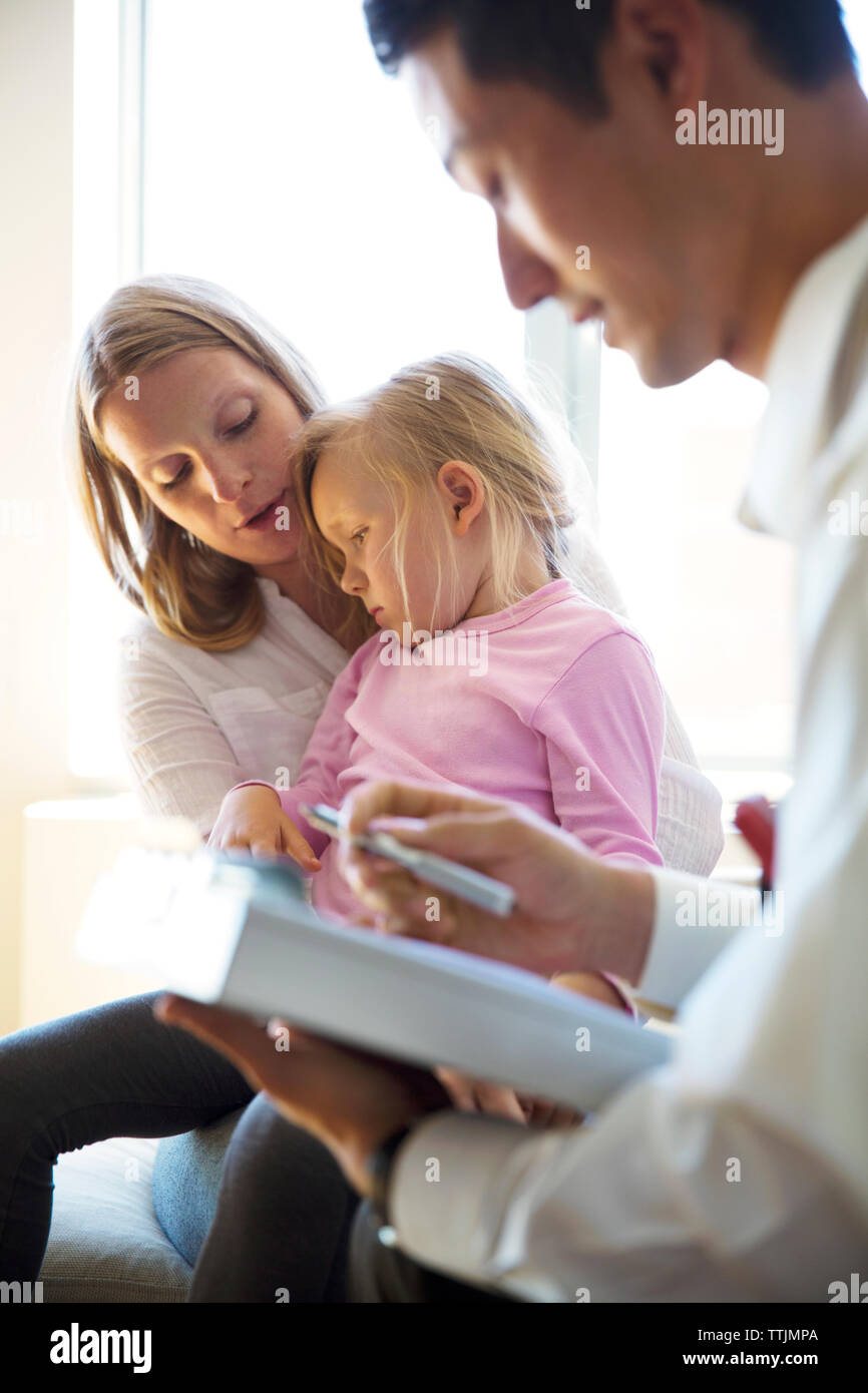 Doctor with patient at home Stock Photo - Alamy