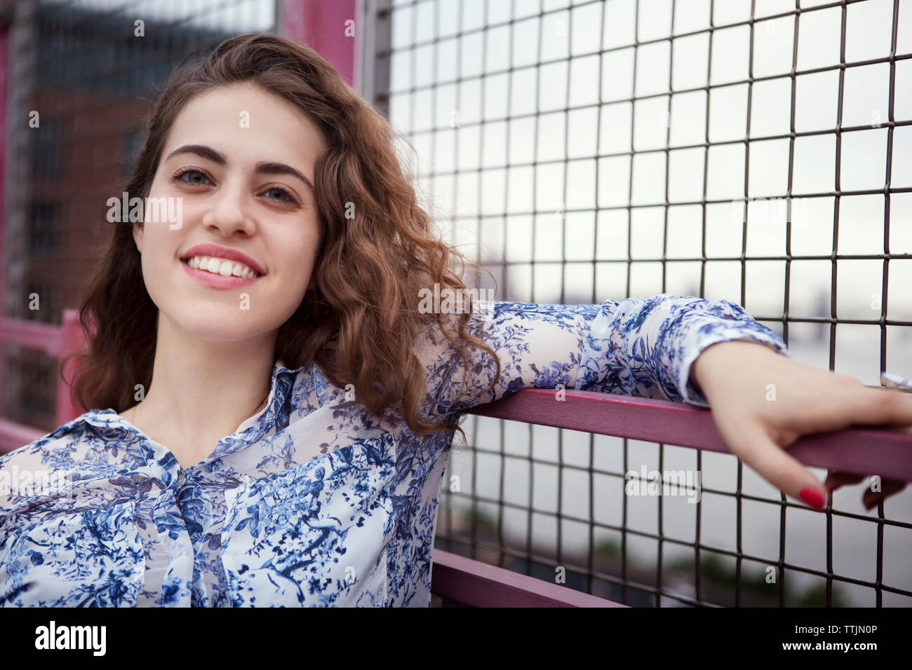 Portrait smiling young woman leaning railing hi-res stock photography ...