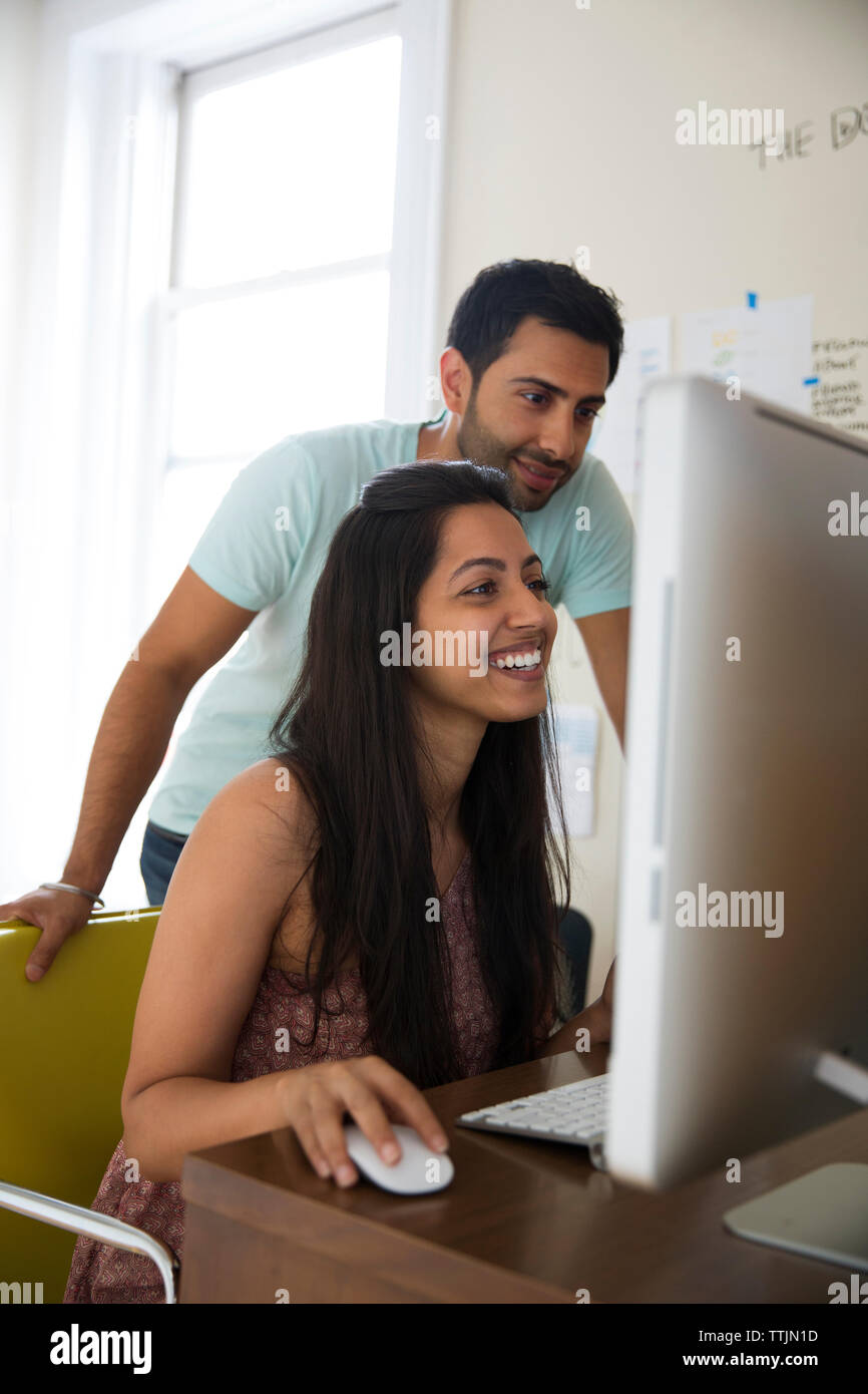 Couple using desktop computer at home Stock Photo - Alamy