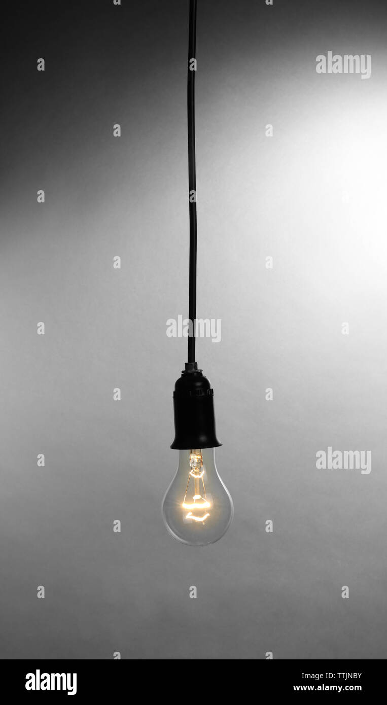 Light bulb on grey background Stock Photo - Alamy