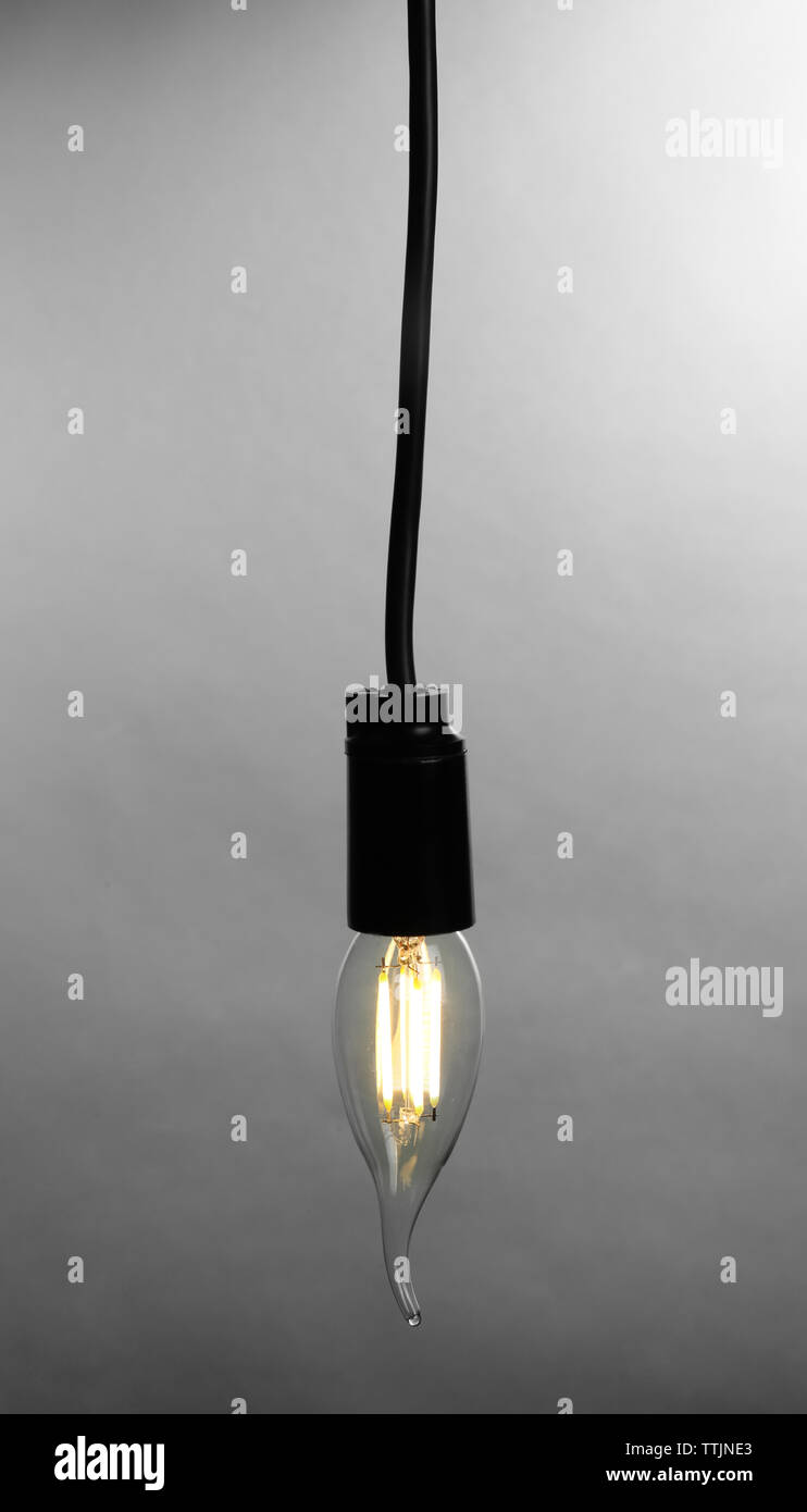 Light bulb on grey background Stock Photo - Alamy