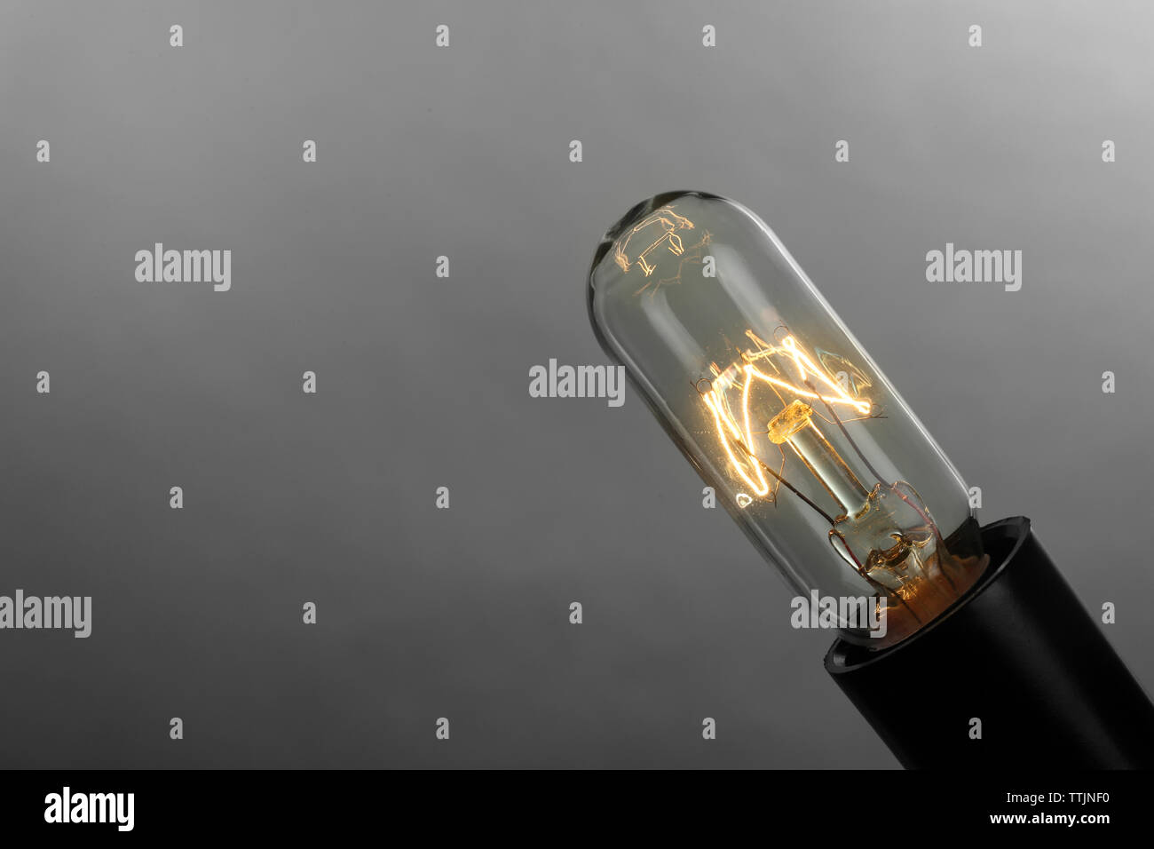 Light bulb on grey background Stock Photo - Alamy