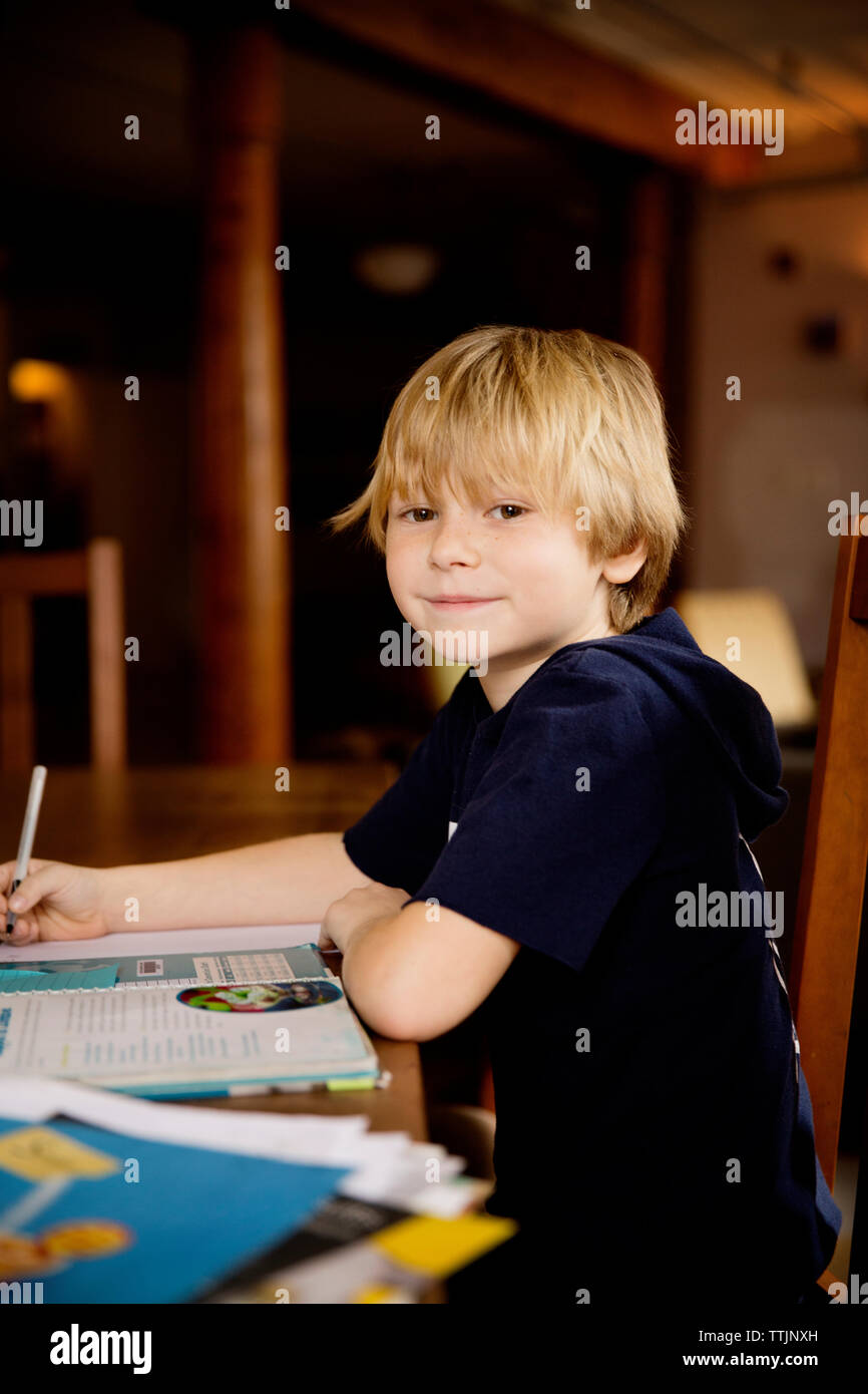 Boy sitting table studying hi-res stock photography and images - Alamy