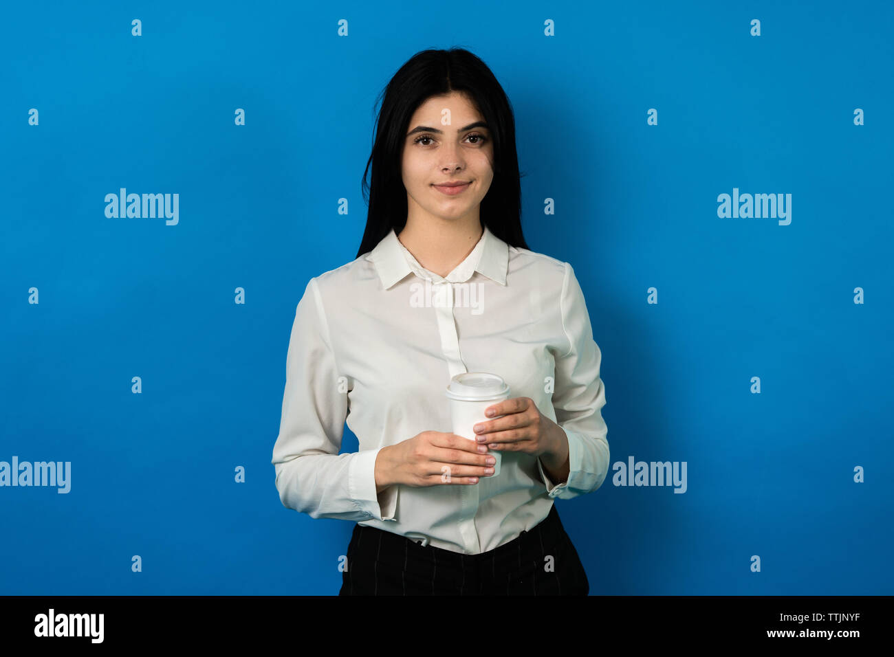bussiness woman with smartphone, look at camera, smile. With copy space ...