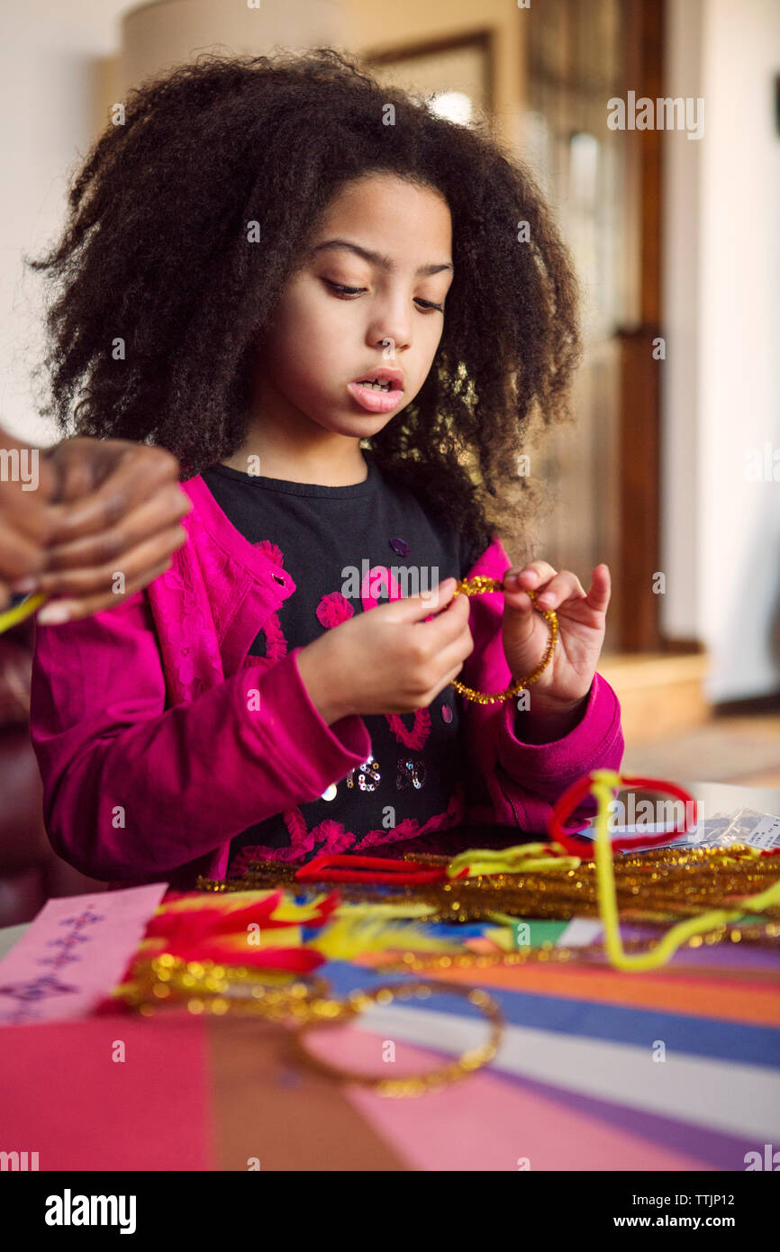 Cute girl making craft with mother at home Stock Photo - Alamy