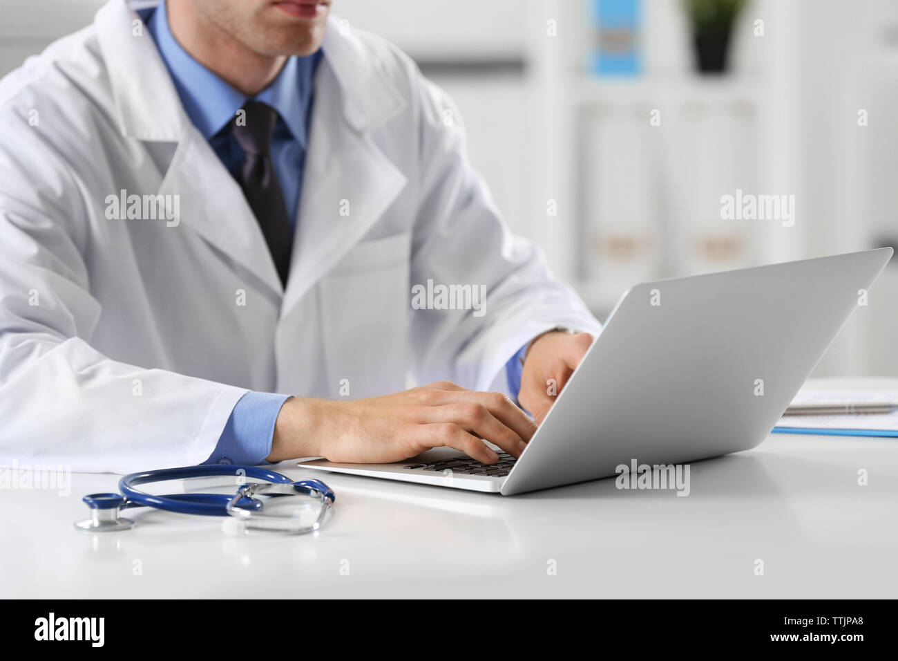 Doctor working on a computer in hospital Stock Photo - Alamy