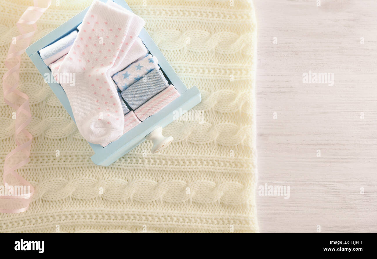 Clean baby linen on knitted plaid Stock Photo - Alamy