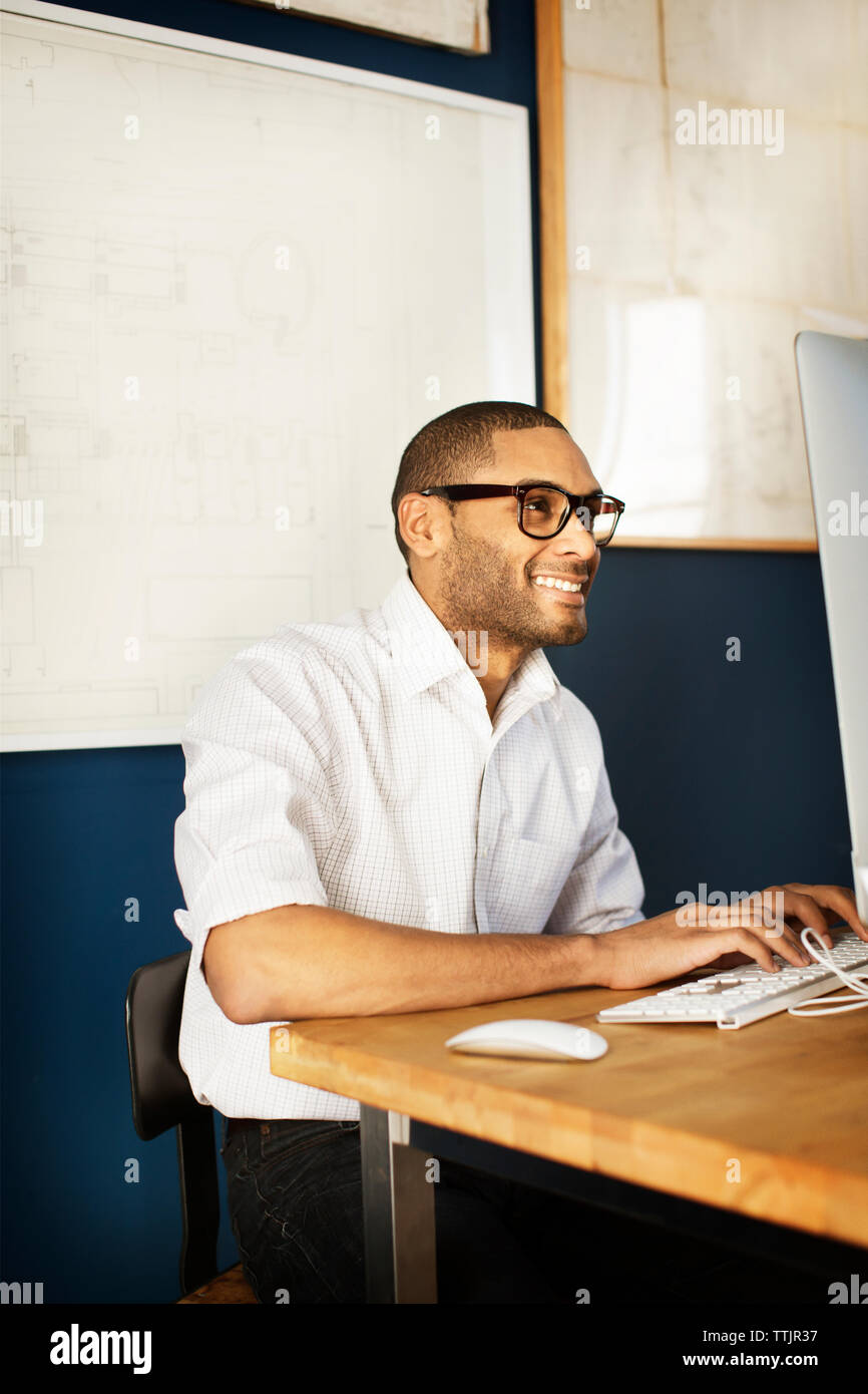 businessman using desktop computer while working in office Stock Photo ...