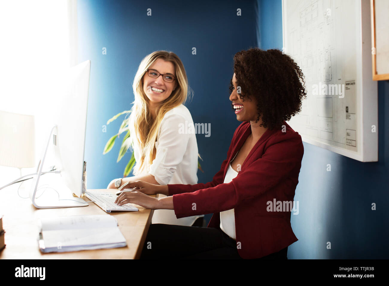 Smiling colleagues working whiteboard office hi-res stock photography ...