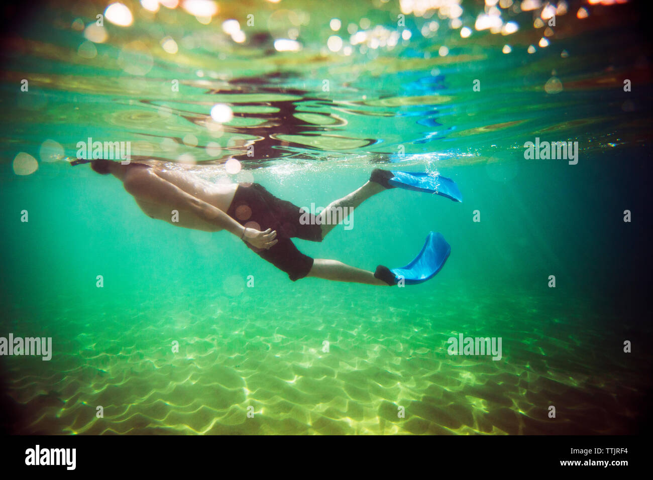 Side view of man swimming in water Stock Photo - Alamy