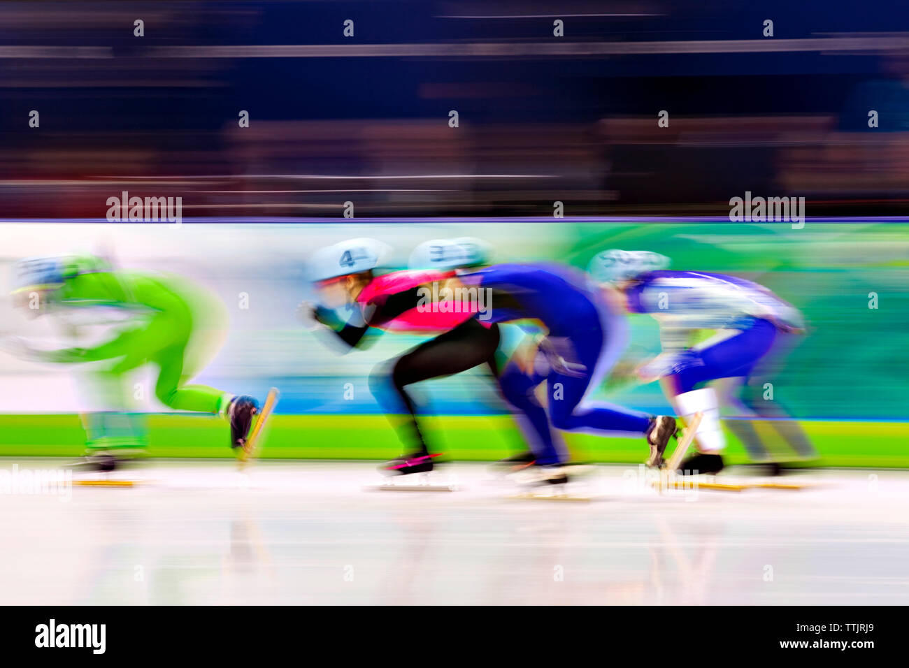 Side view of skaters in skating ring Stock Photo - Alamy