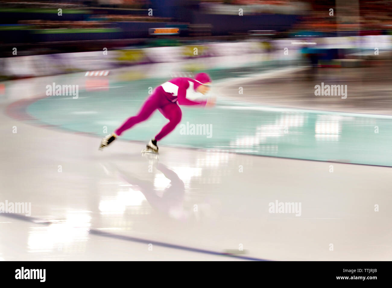 Side view of skater skating in ring Stock Photo - Alamy