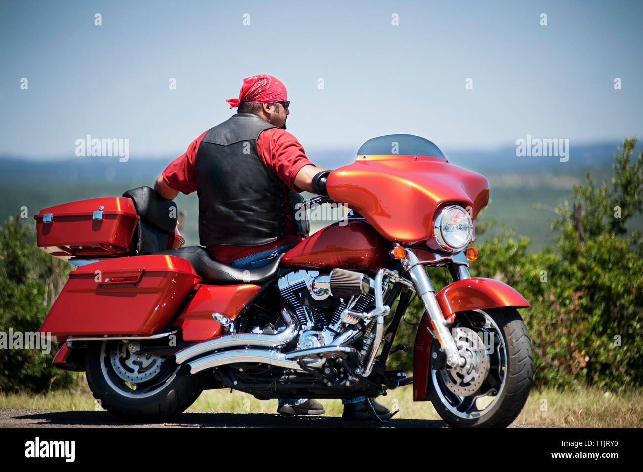 Rear view of man sitting on motorcycle Stock Photo - Alamy