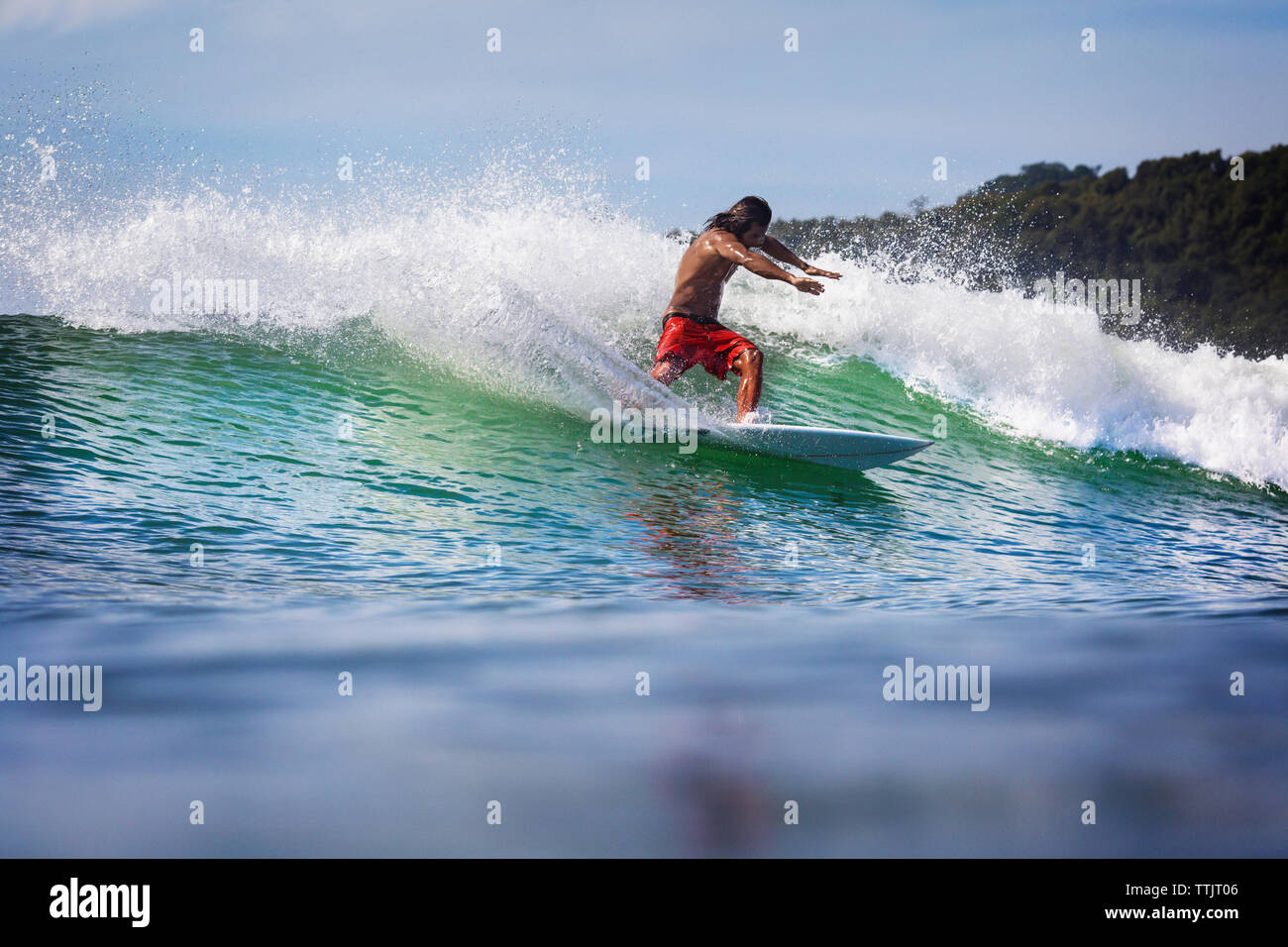 Man surfboarding in sea Stock Photo - Alamy