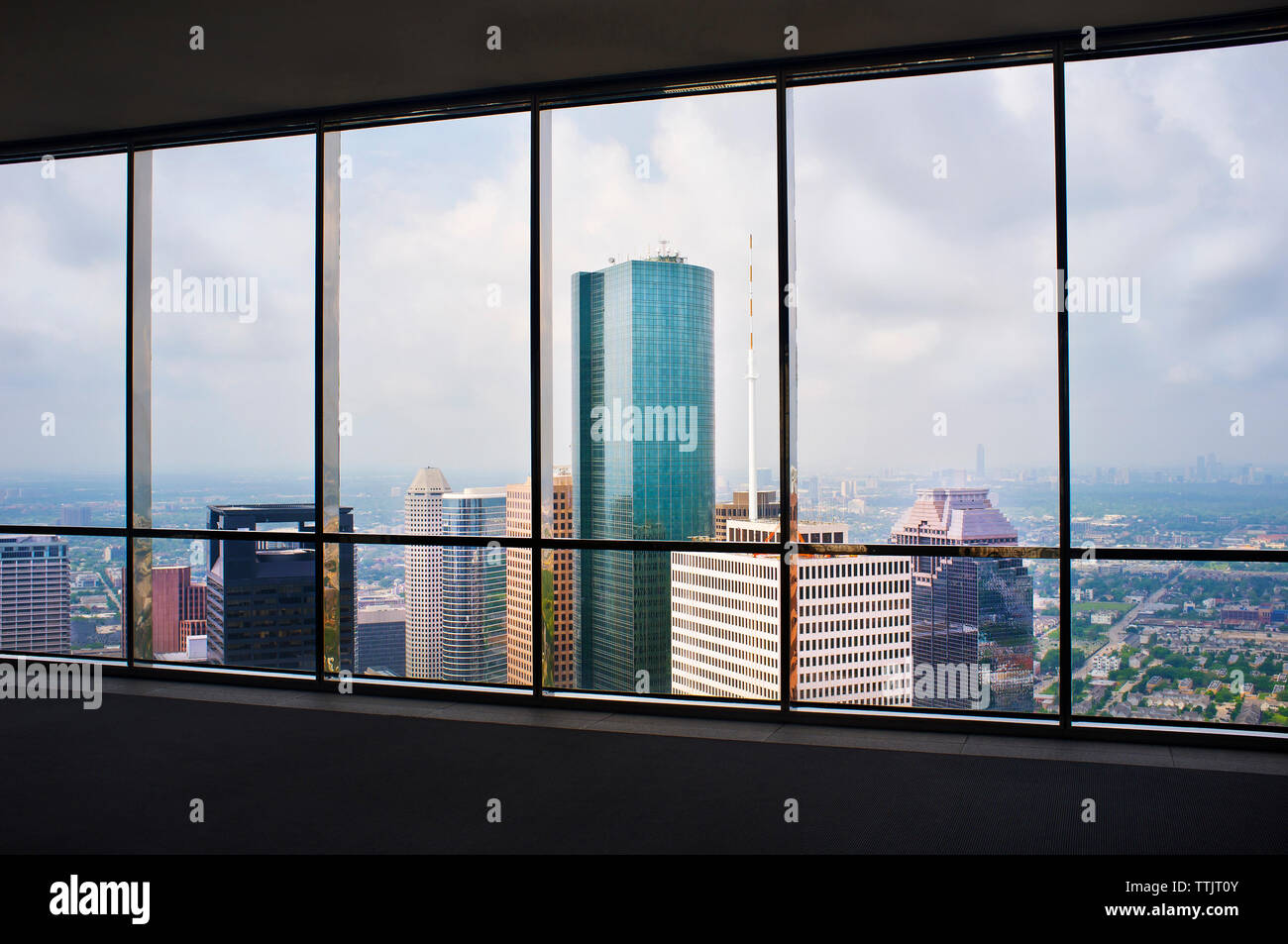 Towers in city seen through window Stock Photo - Alamy