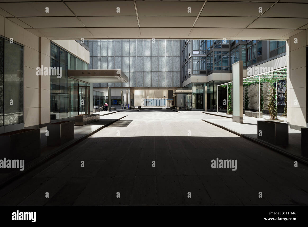 Building seen through covered walkway Stock Photo - Alamy