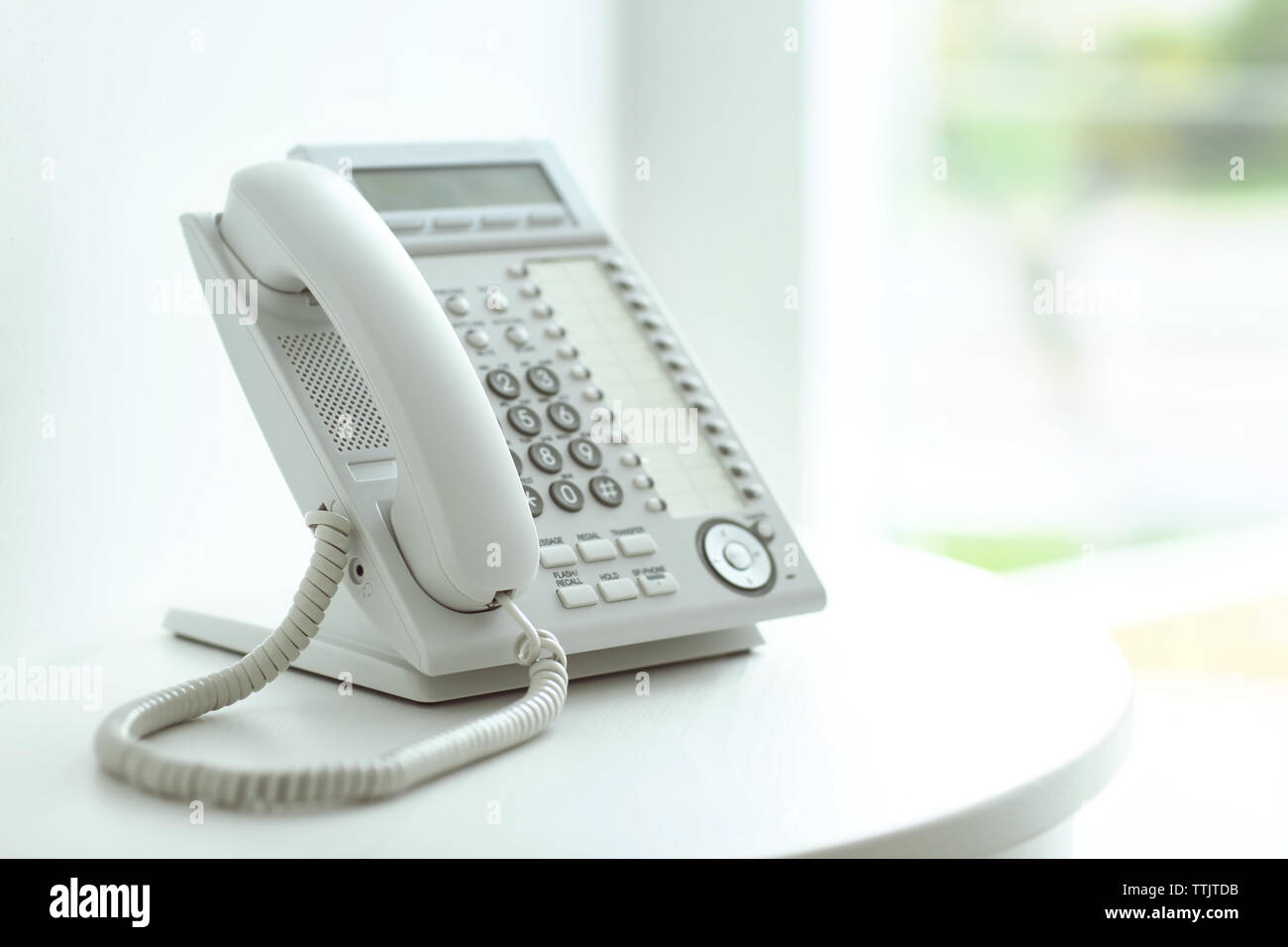 Office IP telephone on light background Stock Photo - Alamy