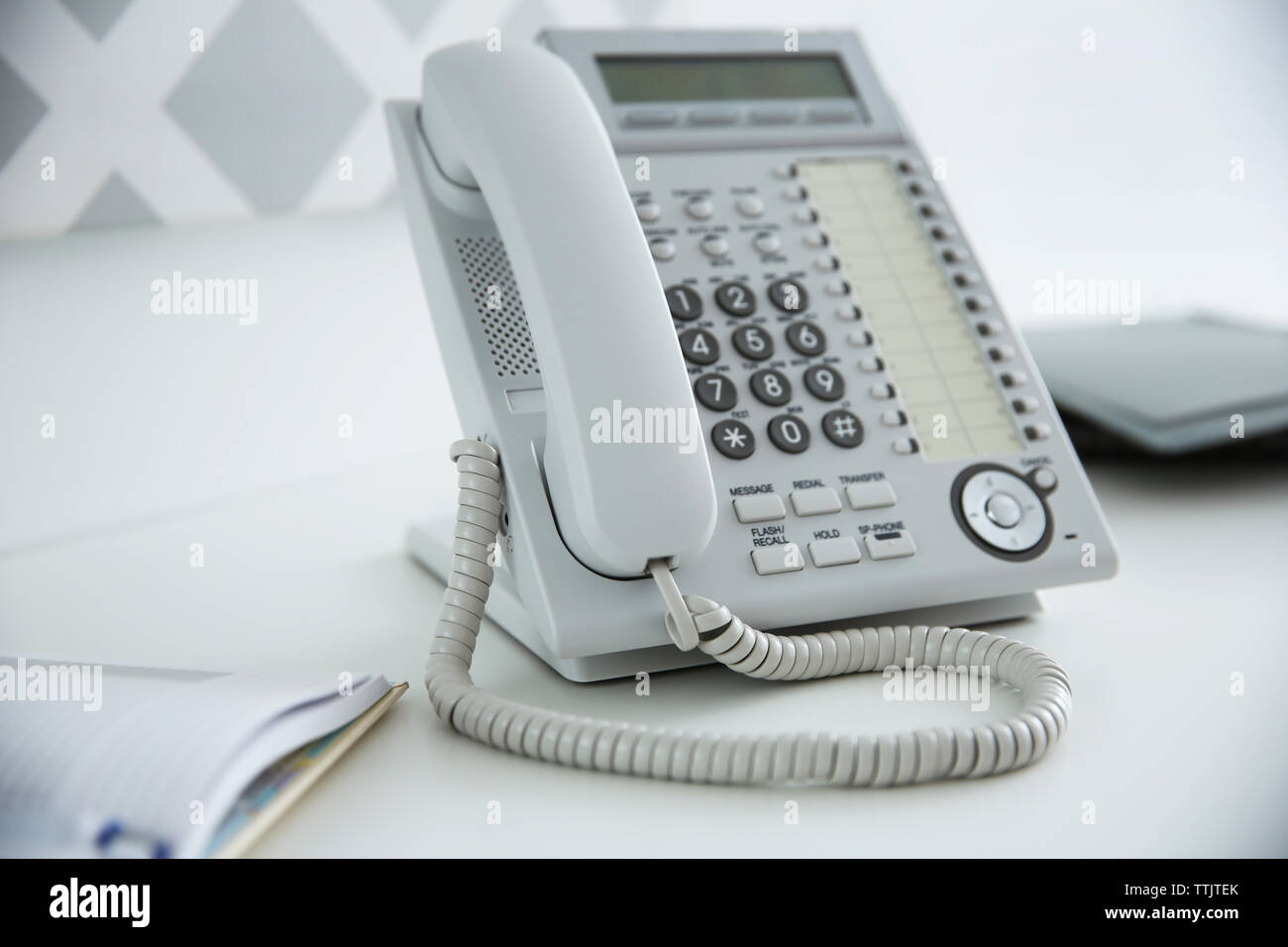 Office IP telephone on light background Stock Photo - Alamy