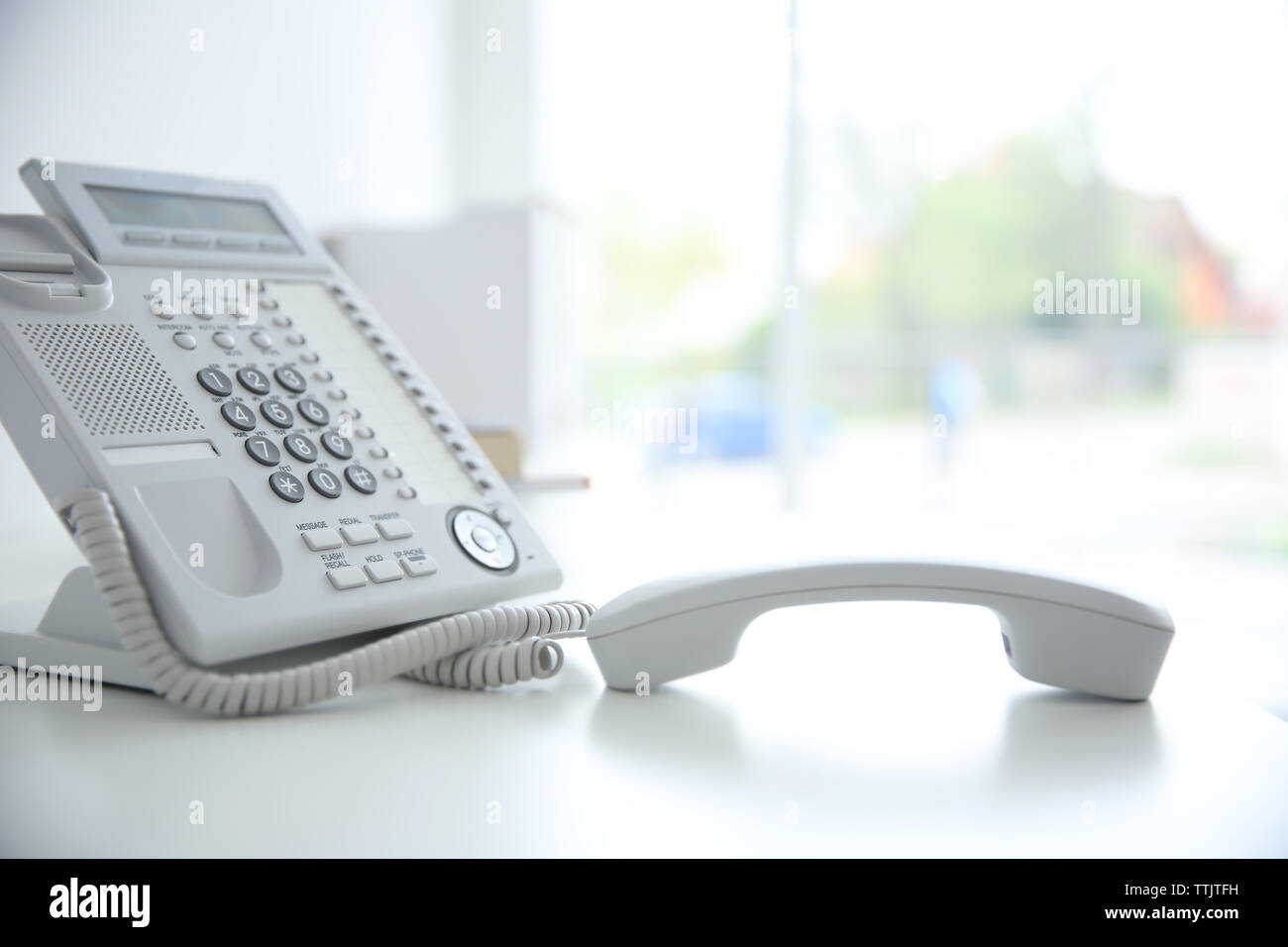 Office IP telephone on light background Stock Photo - Alamy