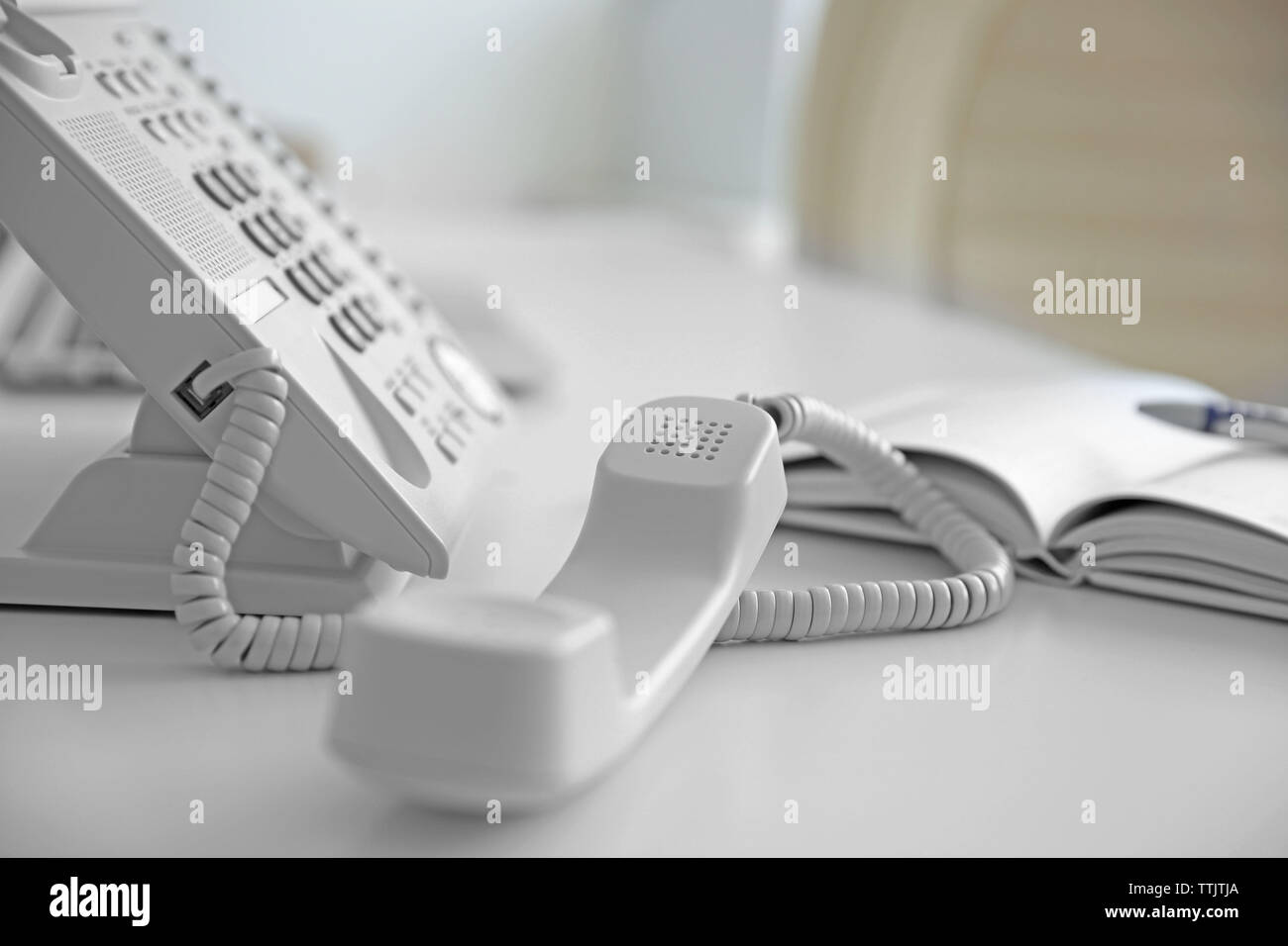 Office IP telephone on light background Stock Photo - Alamy