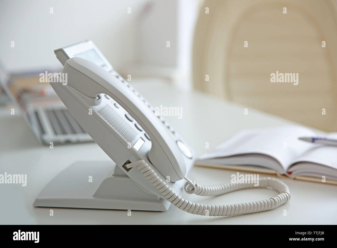 Office IP telephone on light background Stock Photo - Alamy