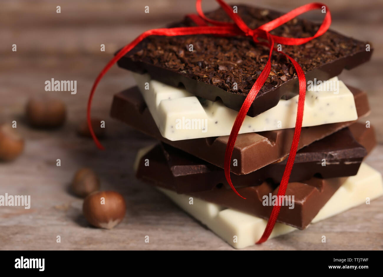 Chocolate bars on wooden background Stock Photo - Alamy