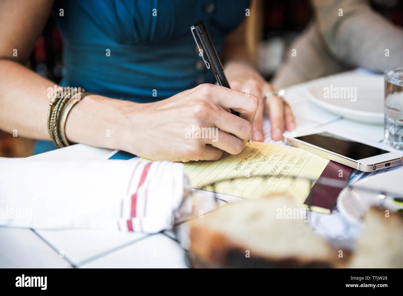 Woman writing in notepad sitting hi-res stock photography and images ...