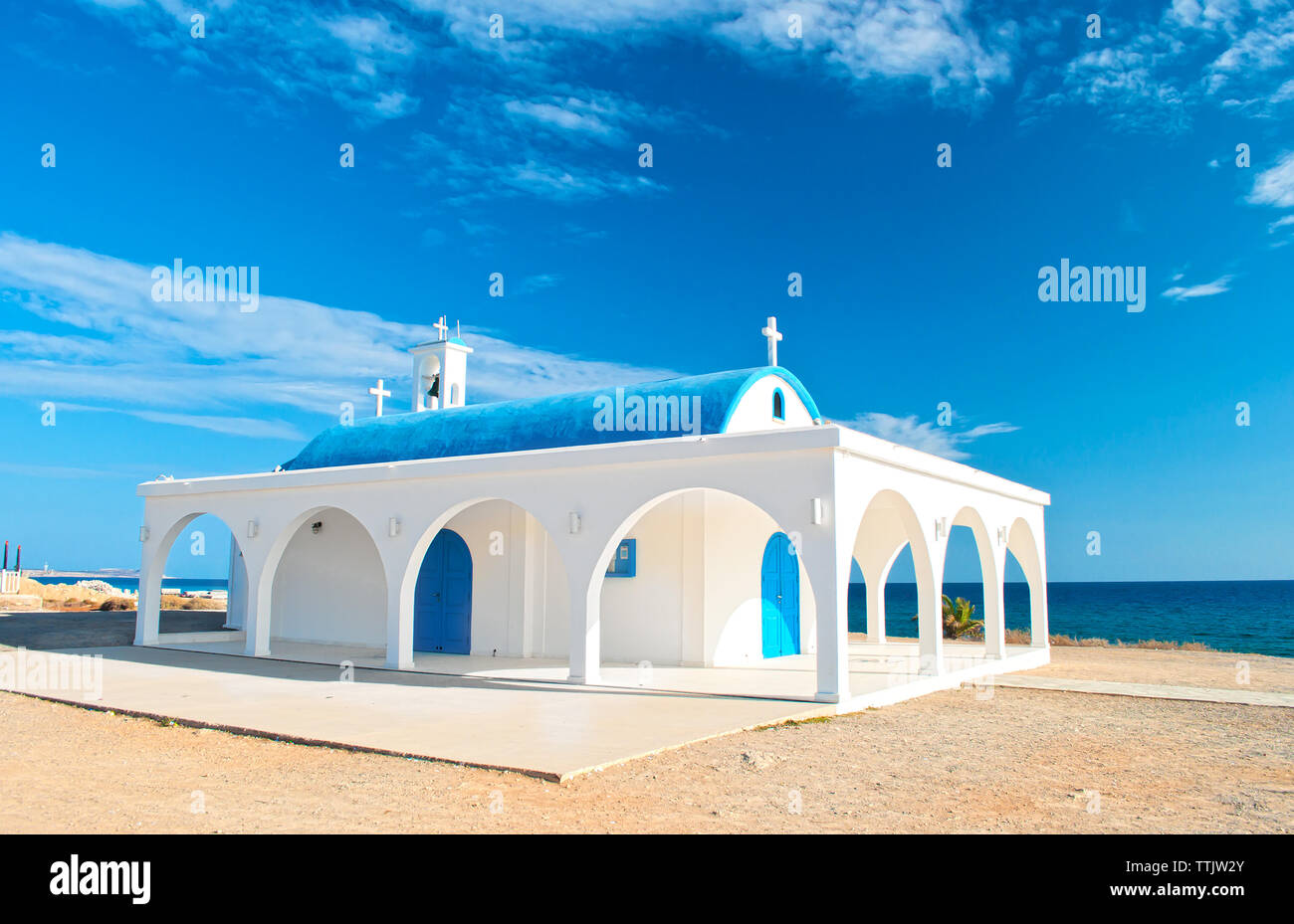White Ayia Thekla Chapel with arched doors near Agia Napa, Cyprus. Deep ...