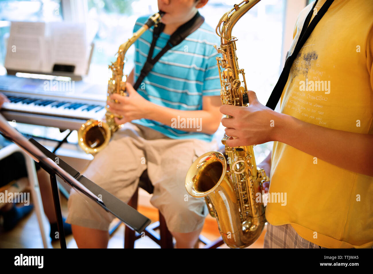 Boys practicing saxophones at home Stock Photo - Alamy