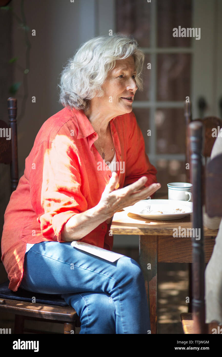 Woman sitting breakfast table hi-res stock photography and images - Alamy
