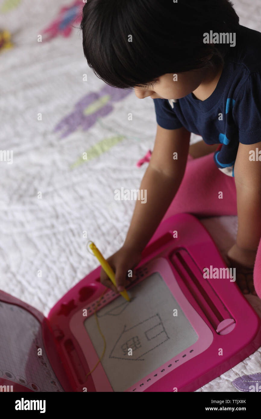 Girl drawing on a magna doodle Stock Photo - Alamy