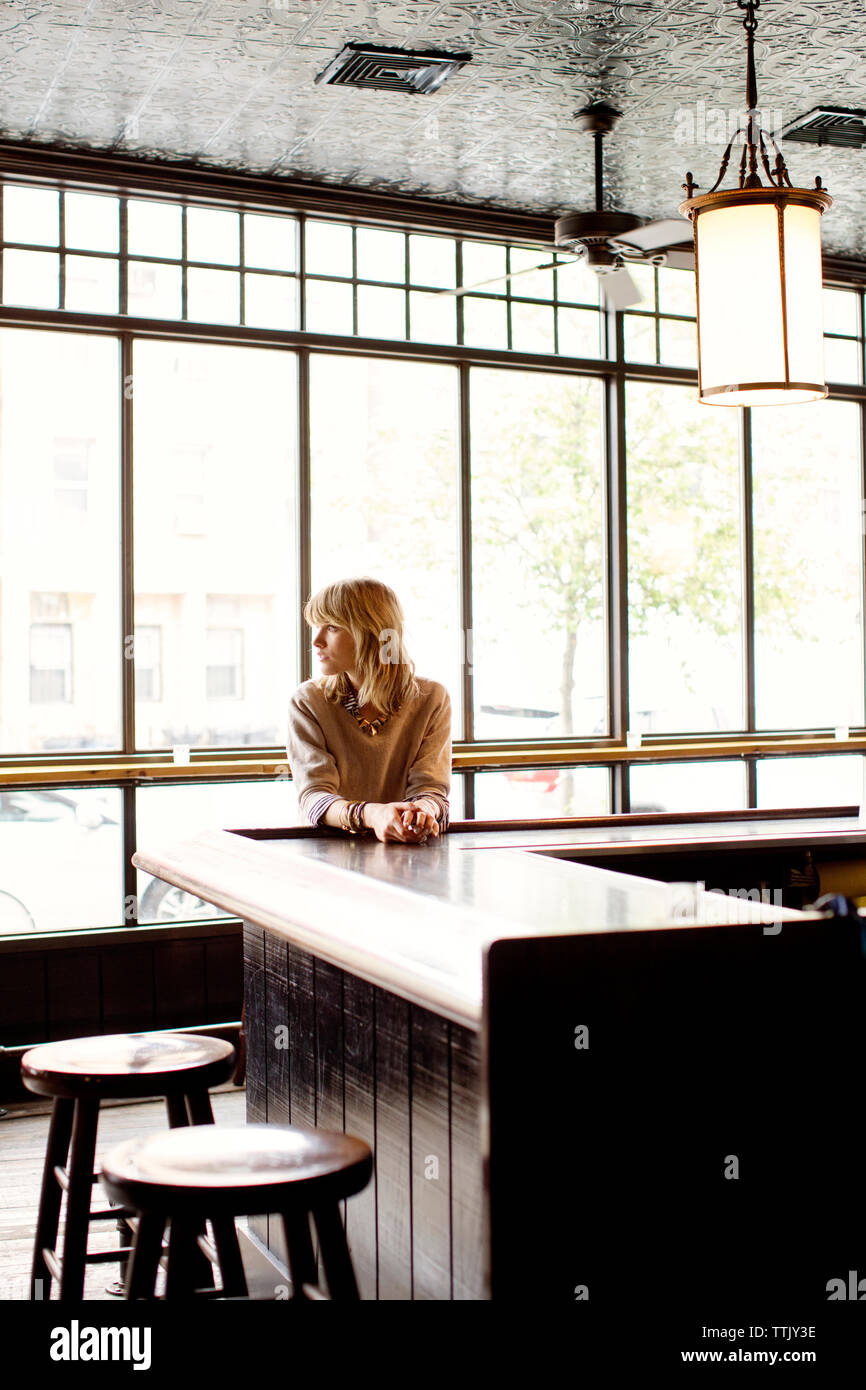 Woman leaning in table hi-res stock photography and images - Alamy