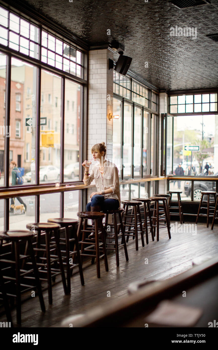 Woman sitting bar drink hi-res stock photography and images - Alamy