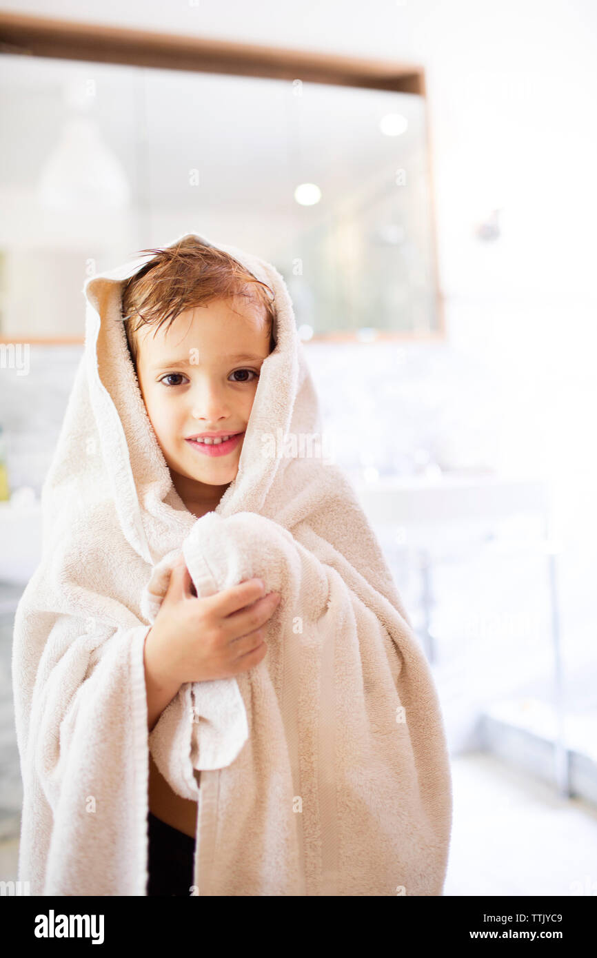 Portrait of boy wrapped in towel Stock Photo - Alamy