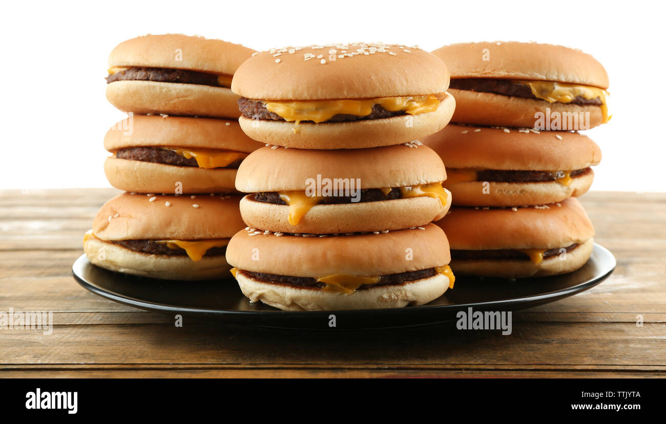 Tasty cheeseburgers on plate, isolated on white Stock Photo - Alamy