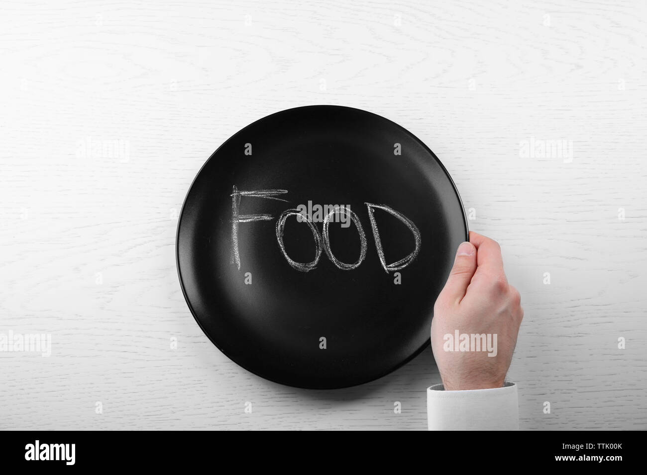 Man holding empty plate. Hunger concept Stock Photo - Alamy