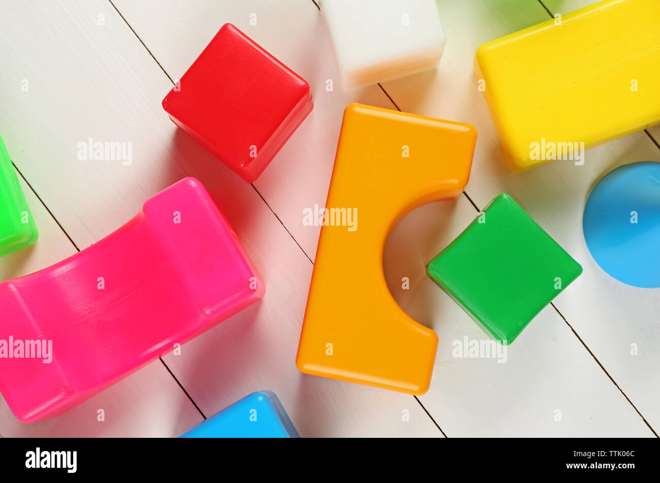 Colorful children's building blocks on white wooden background Stock ...