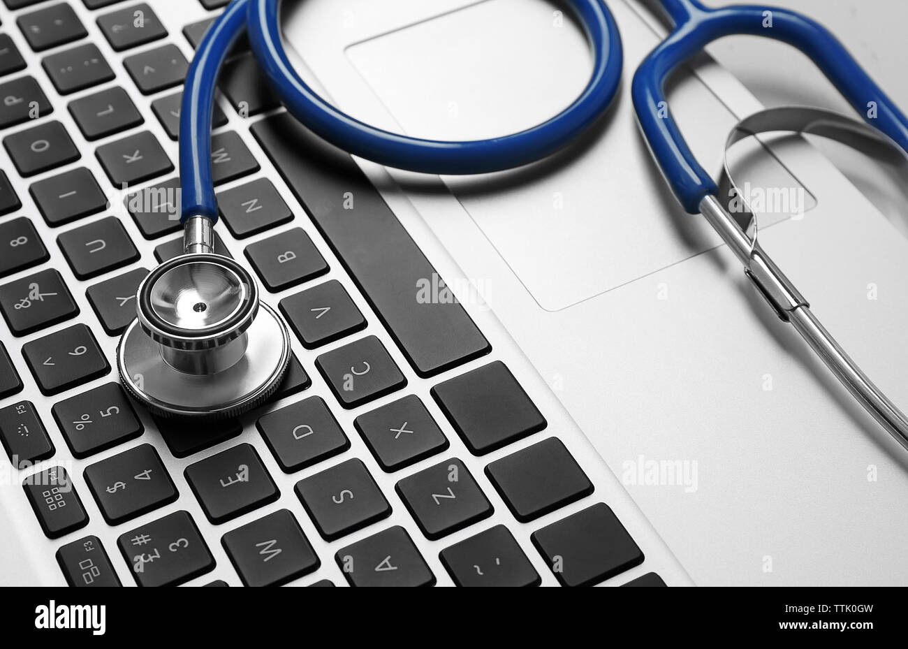 Stethoscope on laptop, close-up Stock Photo - Alamy