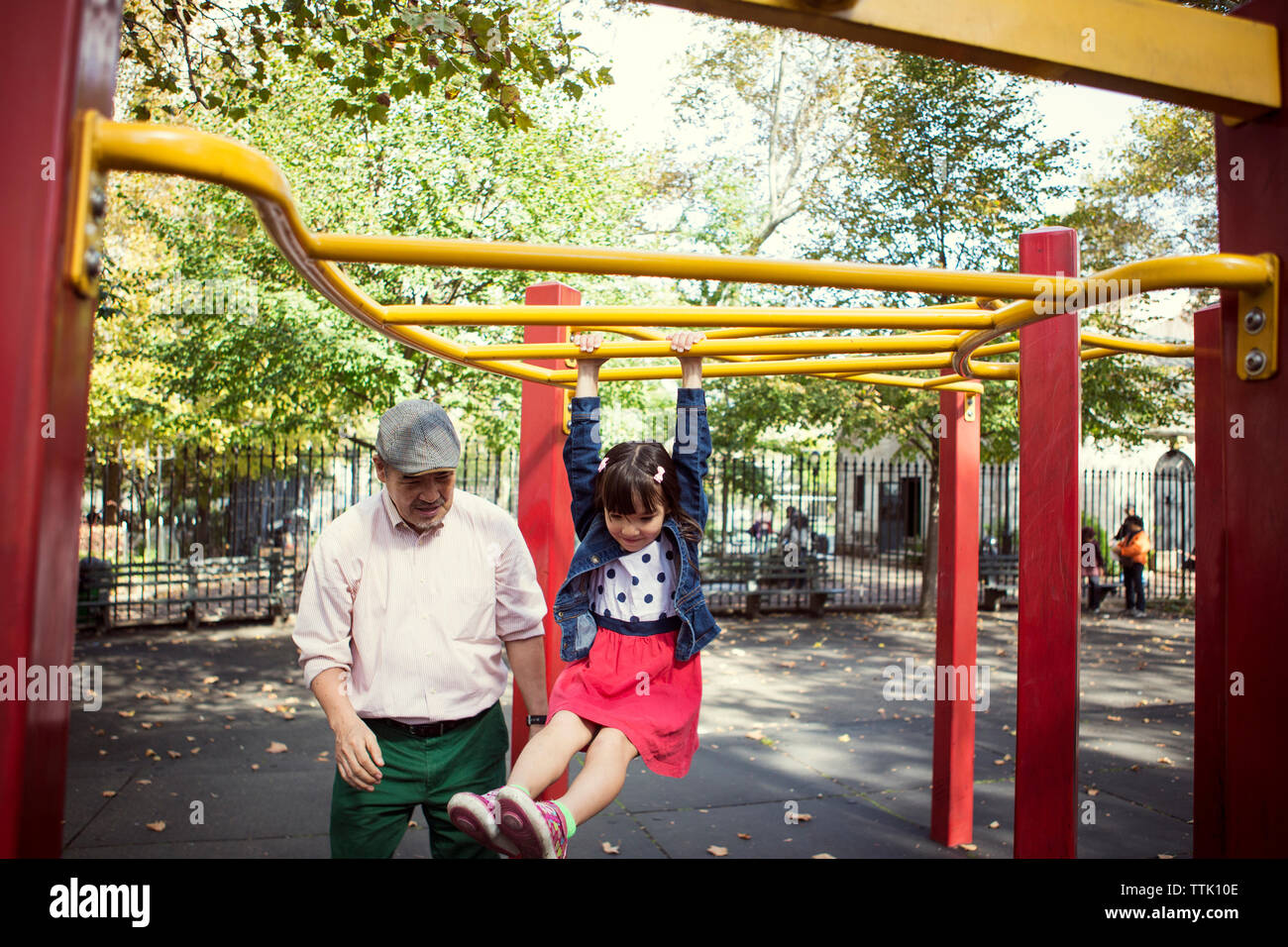 Hanging on jungle gym hi-res stock photography and images - Alamy