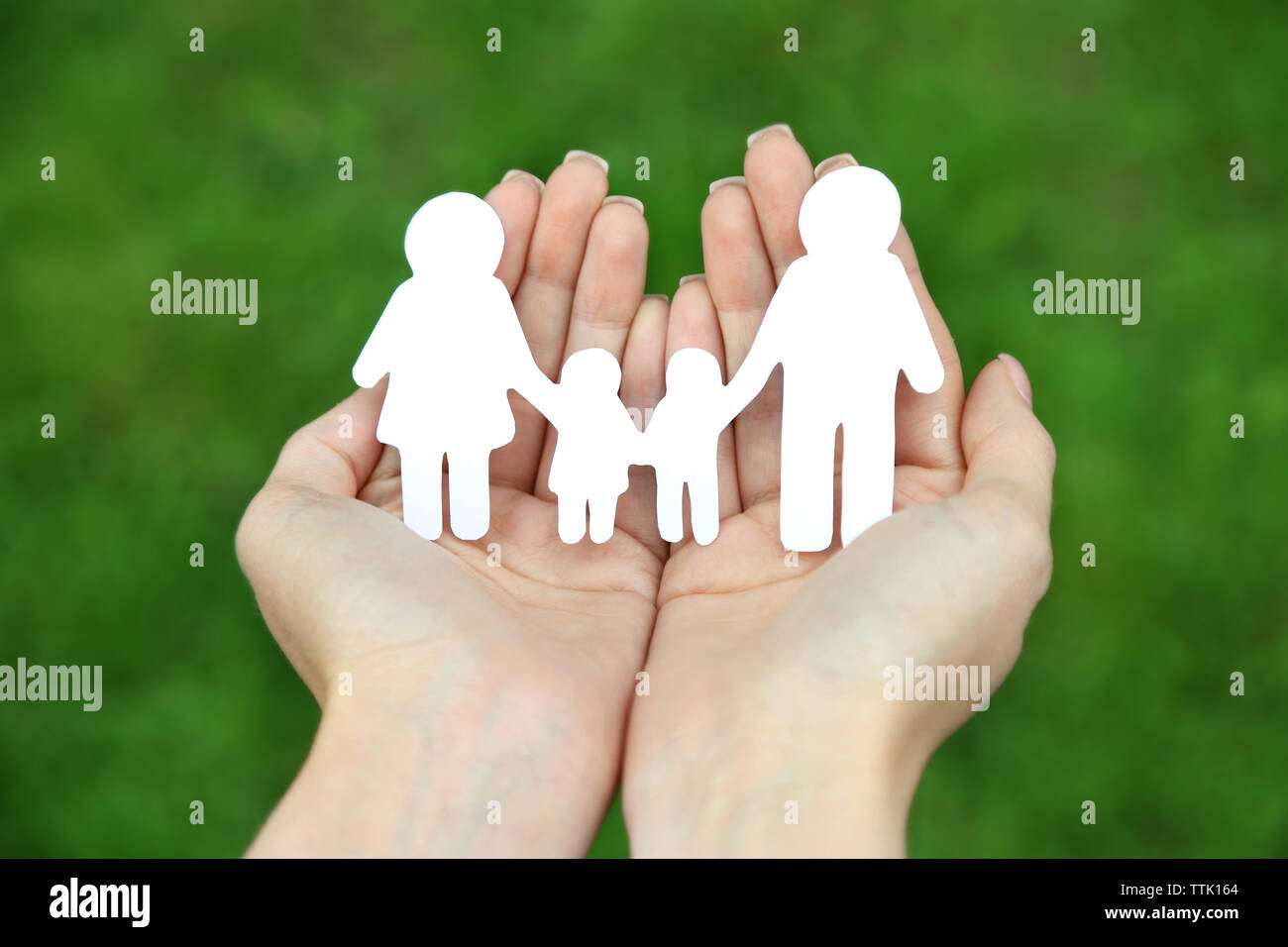 Woman hands holding wooden family shape. Love and relationships concept ...